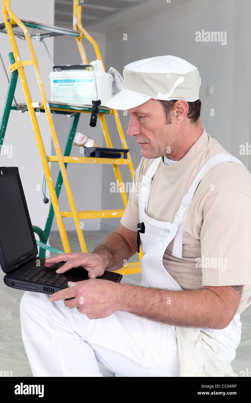 Painter using laptop computer Stock Photo - Alamy