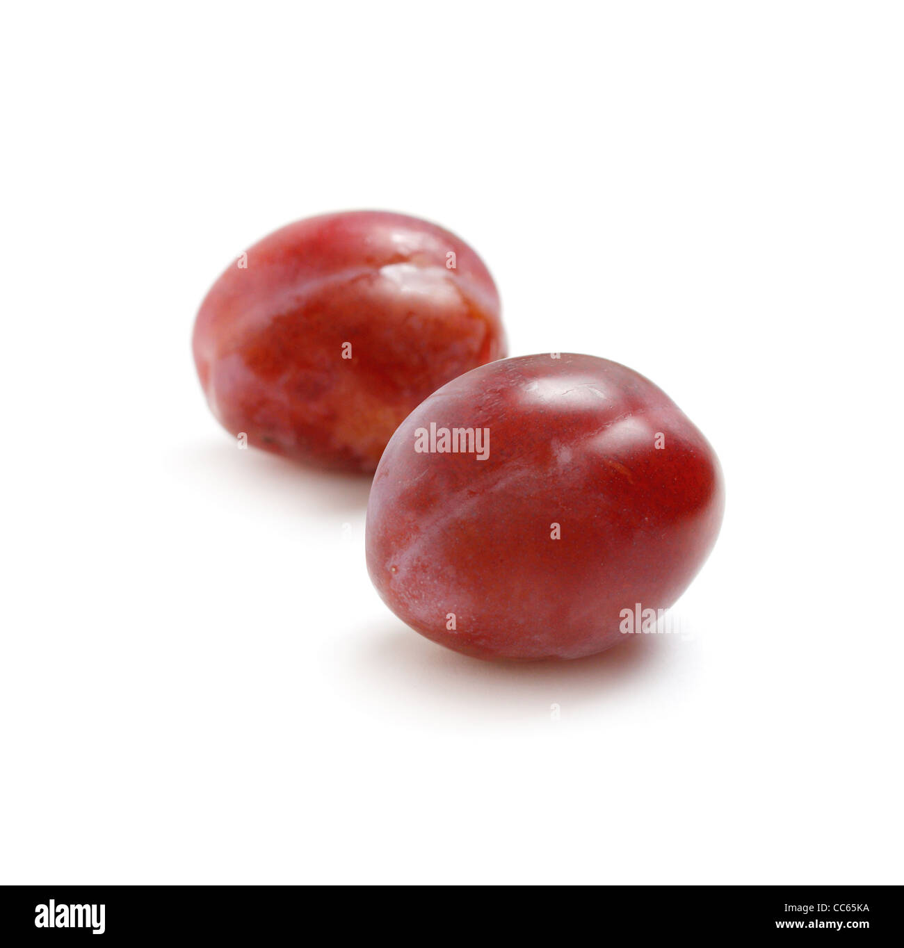 Two plums isolated on white Stock Photo - Alamy
