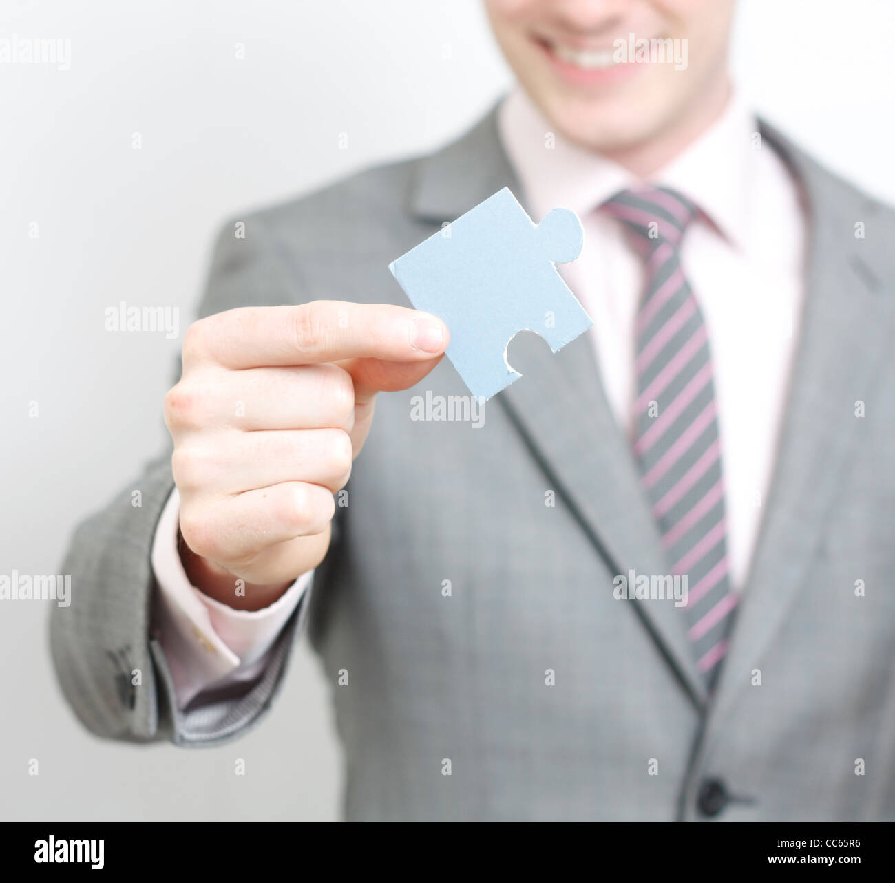 A business man solving a puzzle Stock Photo - Alamy
