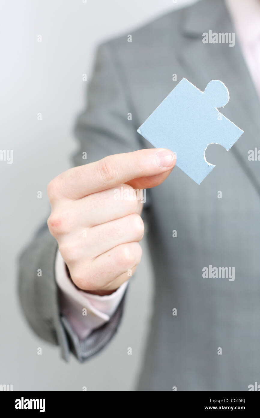 A business man solving a puzzle Stock Photo - Alamy