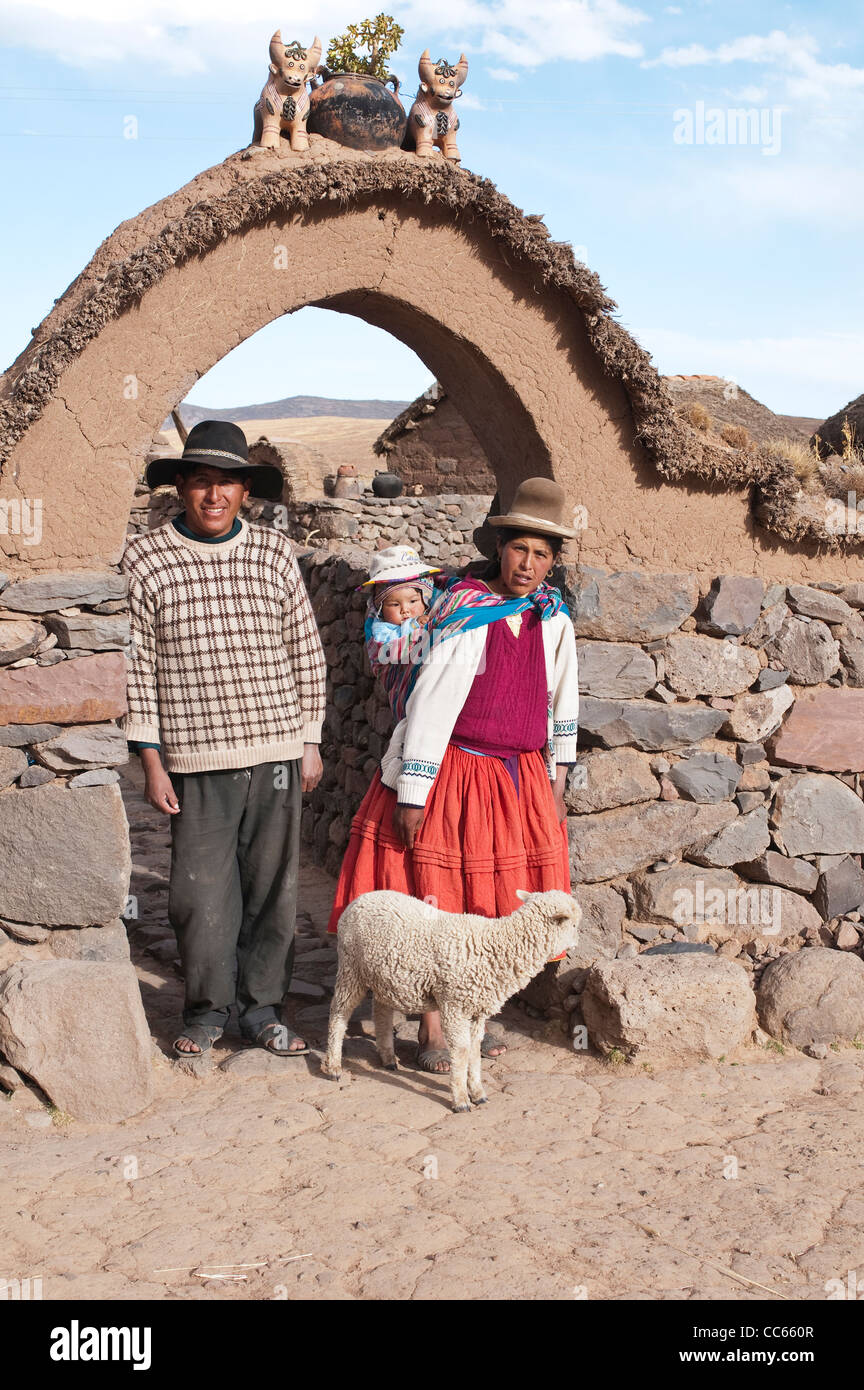 Peru, Atuncolla. Quechua family in front their traditional stone house ...
