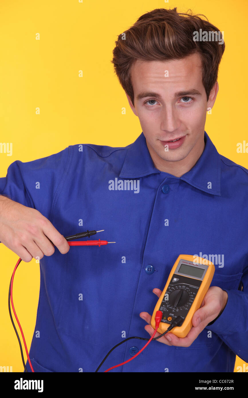 Tradesman posing with a multitester Stock Photo - Alamy