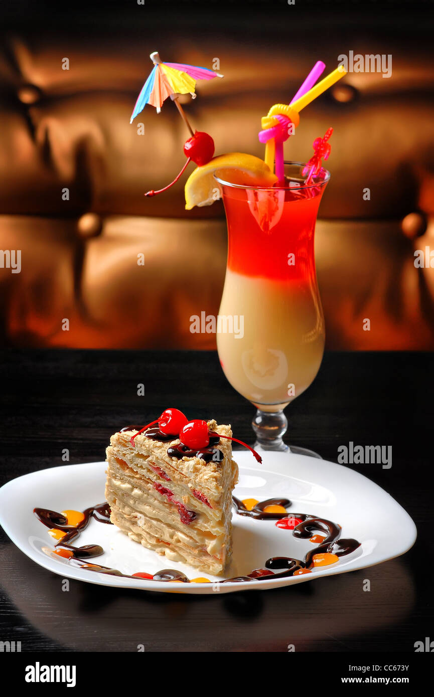 dessert cake on a plate decorated with cherries on a cocktail table ...