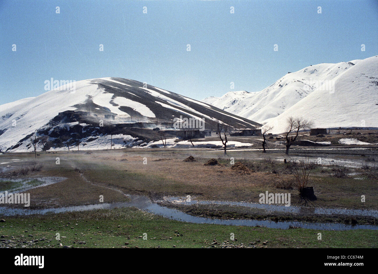Kurdish village at the foot of a mountain near Yuksekova, Turkey. Snow ...