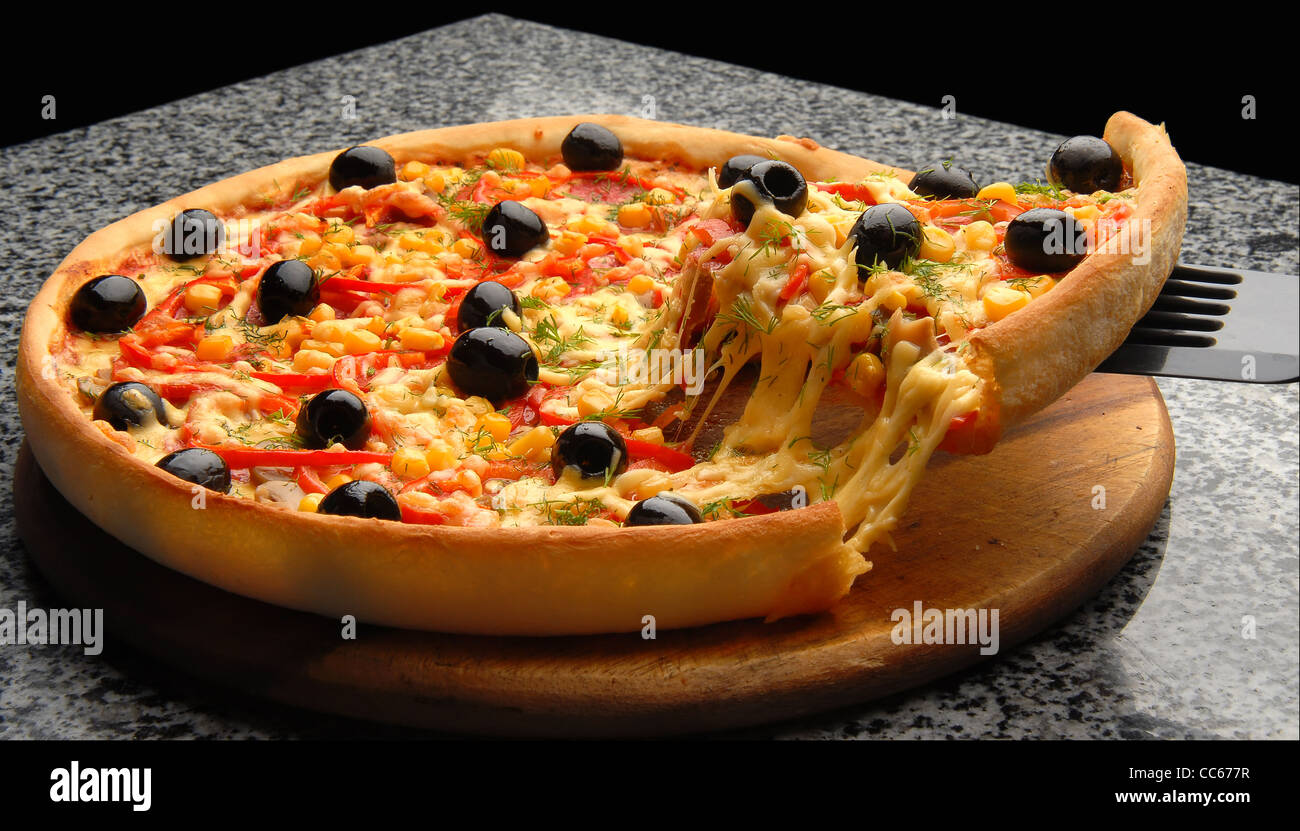 Round Italian pizza with salami, olives, capsicum and cheese Stock ...