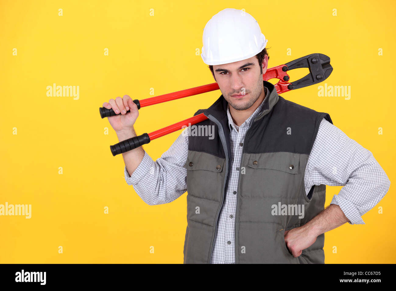 Tradesman carrying a pair of large clippers on his shoulder Stock Photo ...