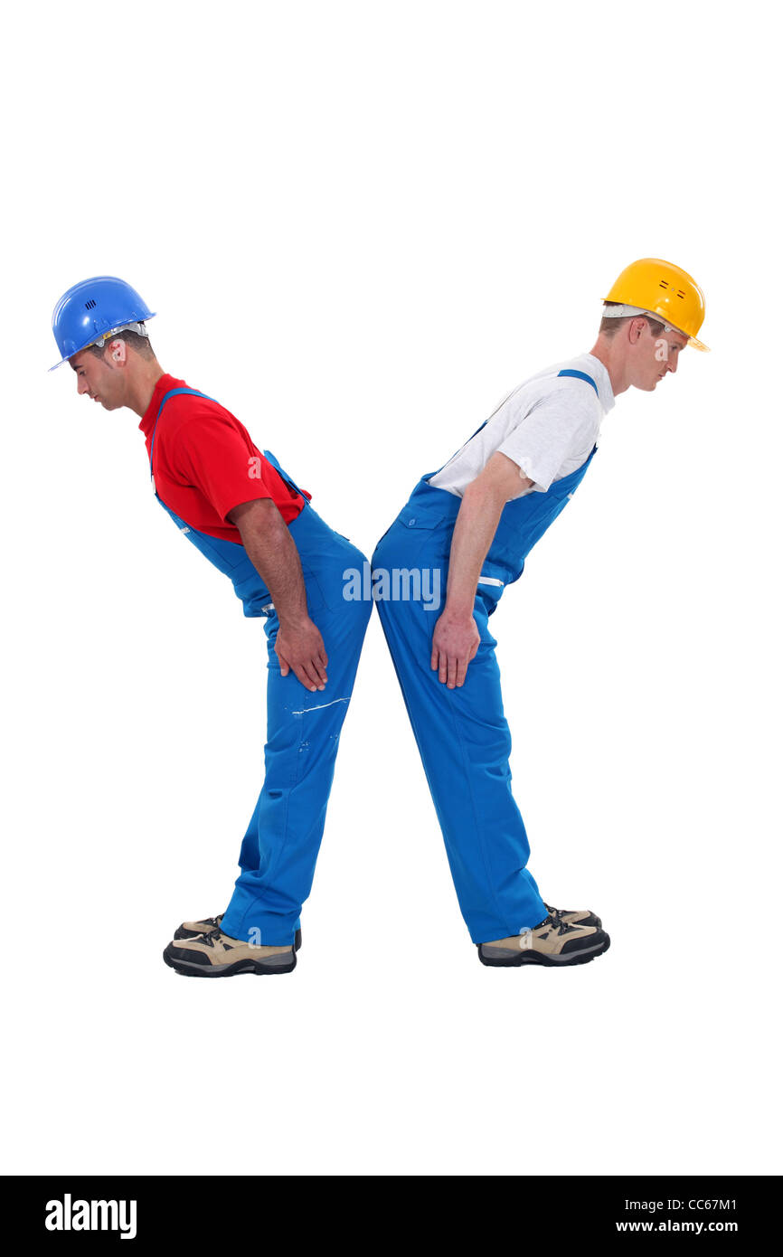 Two builders forming the letter X Stock Photo - Alamy