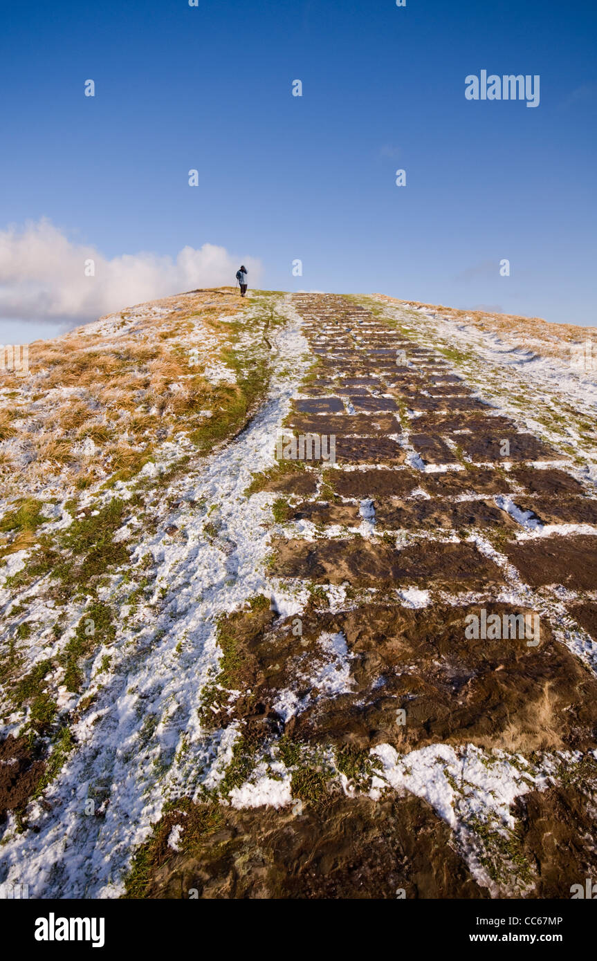 A hiker on the path to the summit of Mam Tor in the Peak District ...