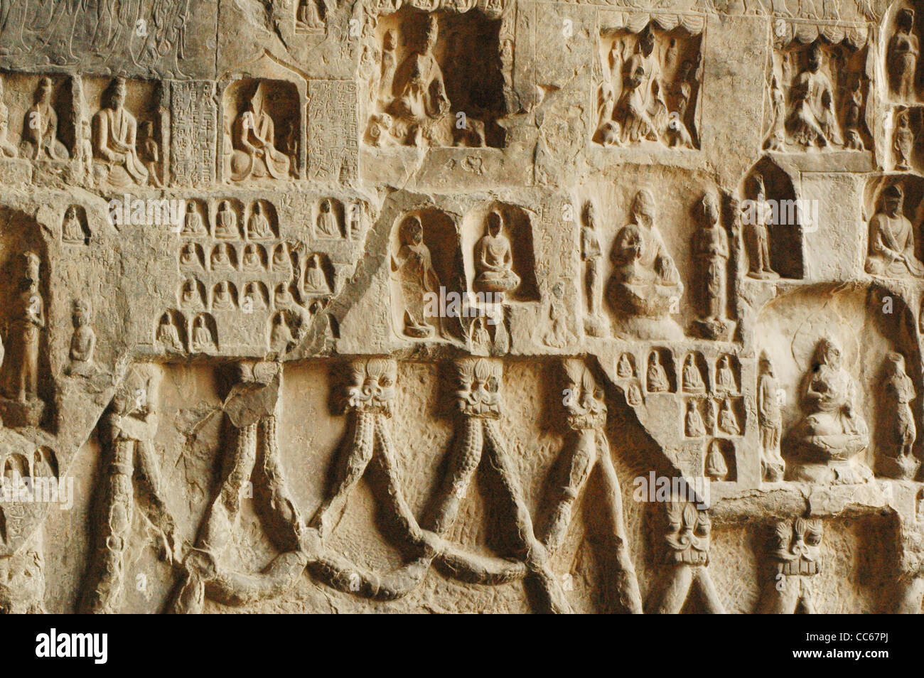 Stone wall carved with Buddha, Longmen Grottoes, Luoyang, Henan , China ...