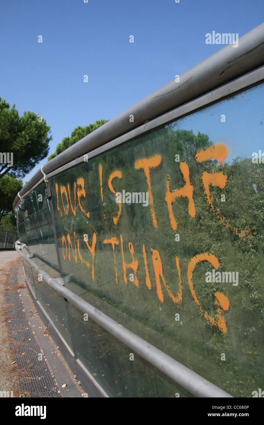 love is the only thing graffiti painted on glass panel on bridge in ...