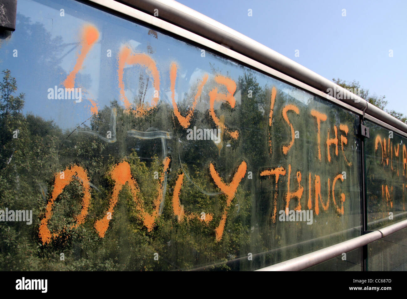 love is the only thing graffiti painted on glass panel on bridge in ...