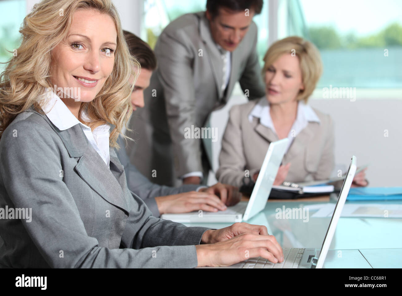 Using laptops in an office Stock Photo - Alamy
