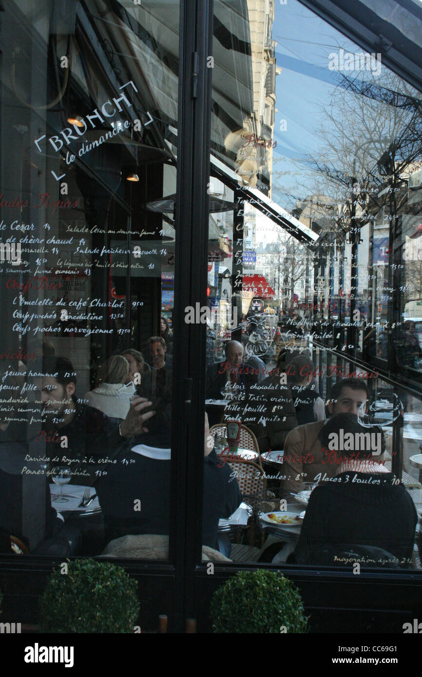 French brasserie, menu written window with customers on the background ...
