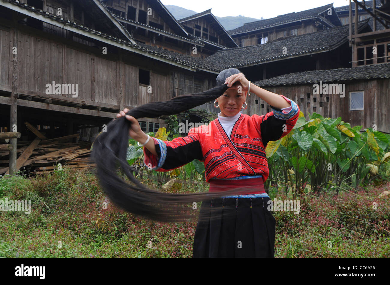 Red Yao woman coiling her long hair, Huangluo Yao Village, Longsheng ...