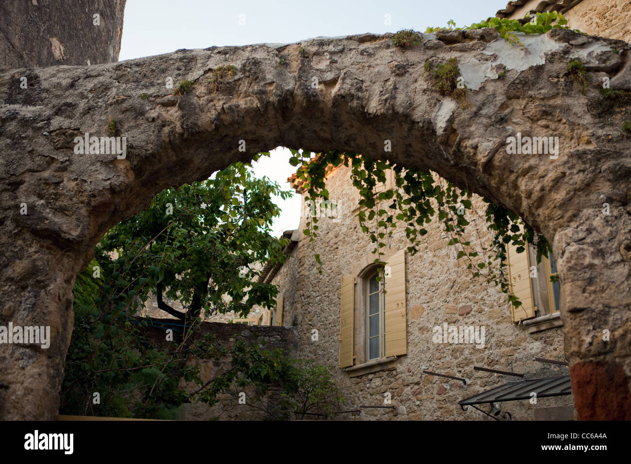 An old stone archway in the town of Lourmarin, in Provence, France ...