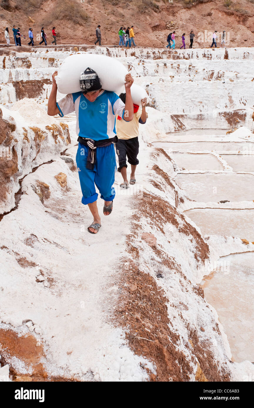 Inca men man workers carrying bags bag at Salinas De Maras terraced ...