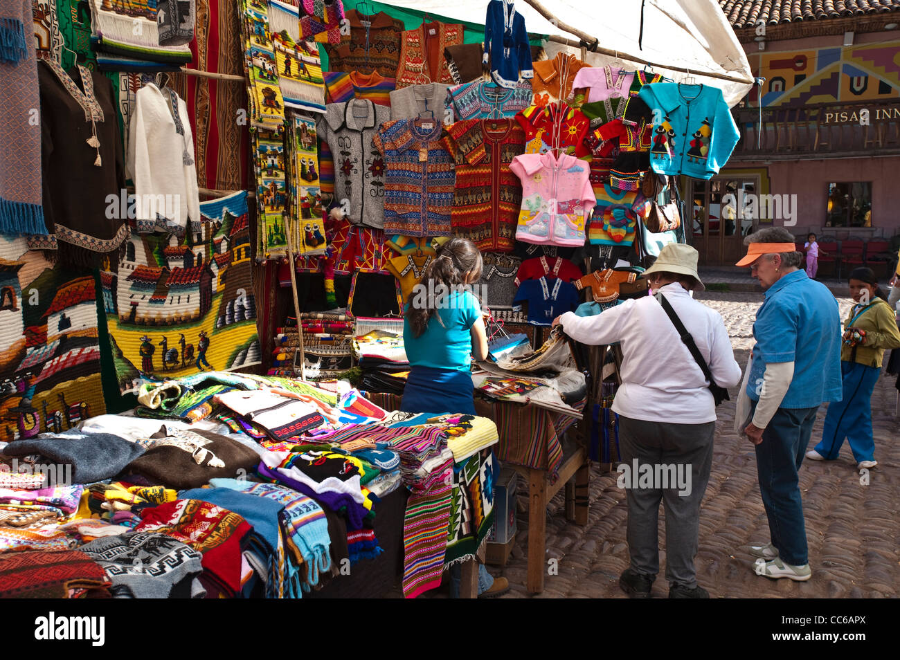 Shopping for souvenirs at the arts and craft market, Urubamba, Peru ...