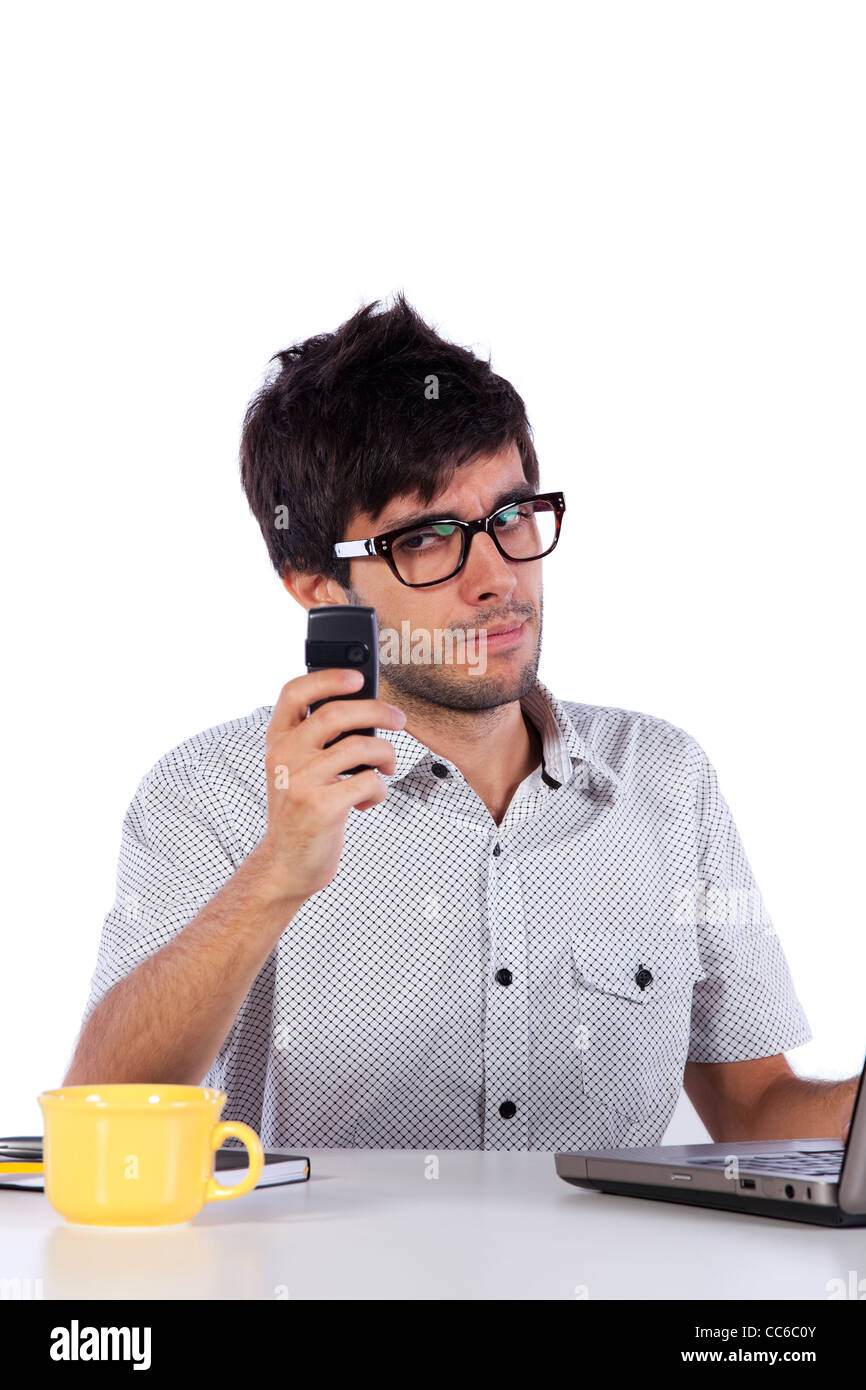 Young modern businessman with a suspicious look at his mobile phone ...