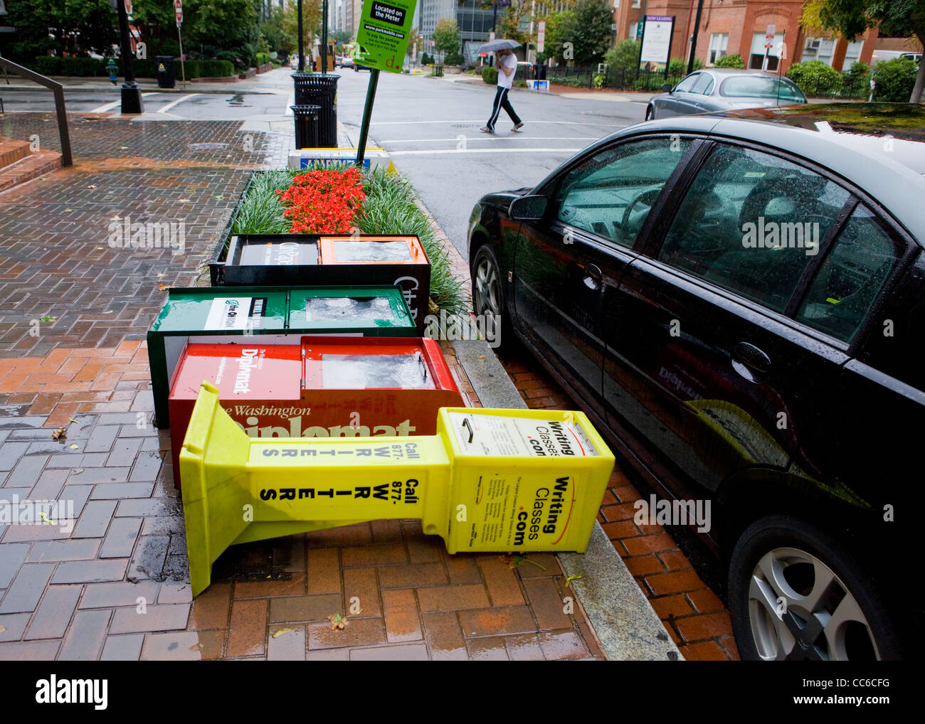 Fallen newspaper vending machines in rain Stock Photo - Alamy