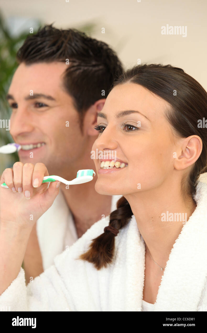 Couple brushing teeth Stock Photo - Alamy
