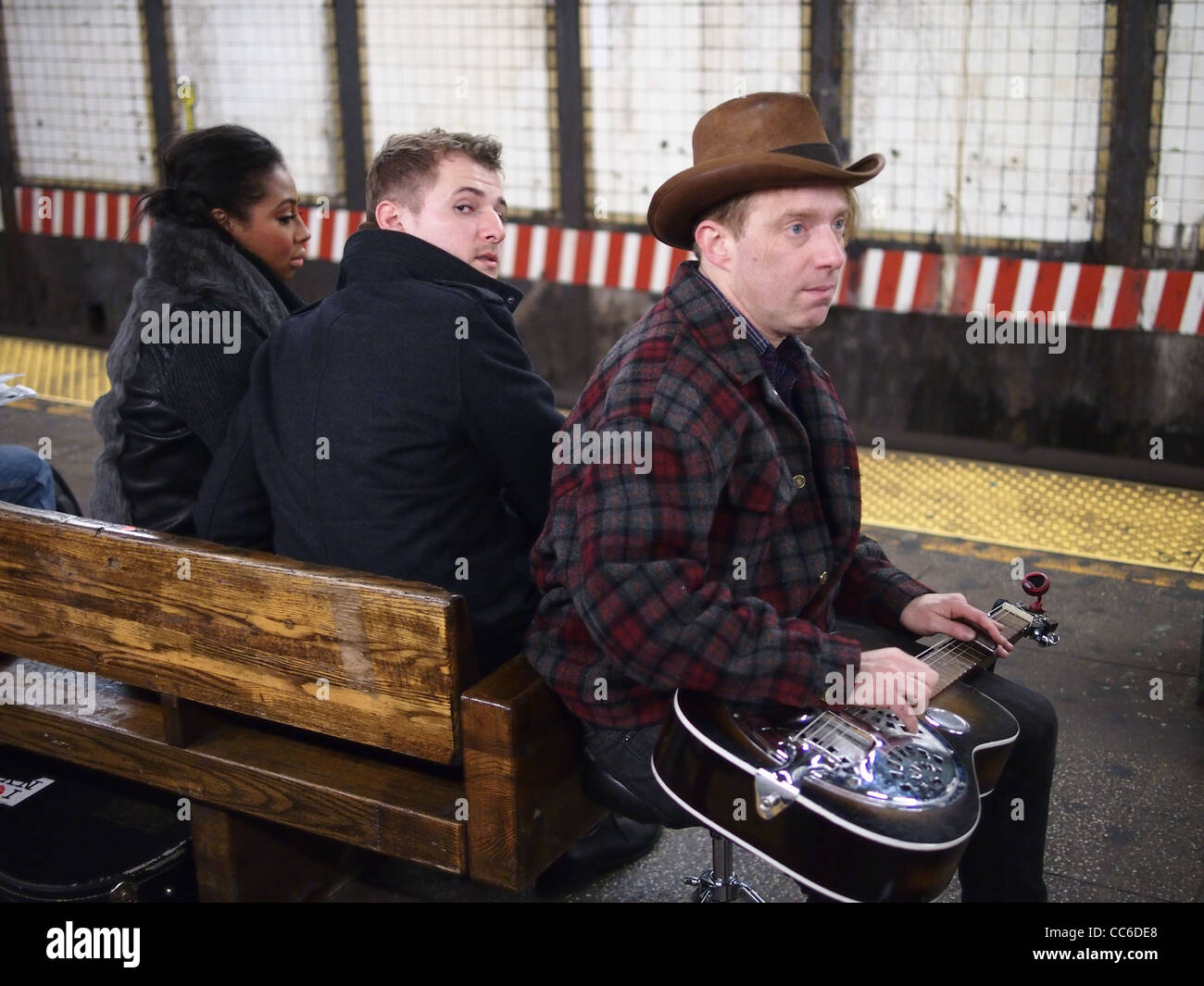 Musician playing dobro on New York City subway, L train, Bedford Avenue ...