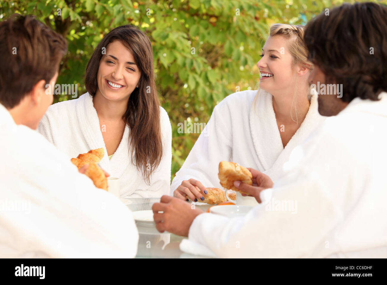 Four friends sharing breakfast Stock Photo - Alamy