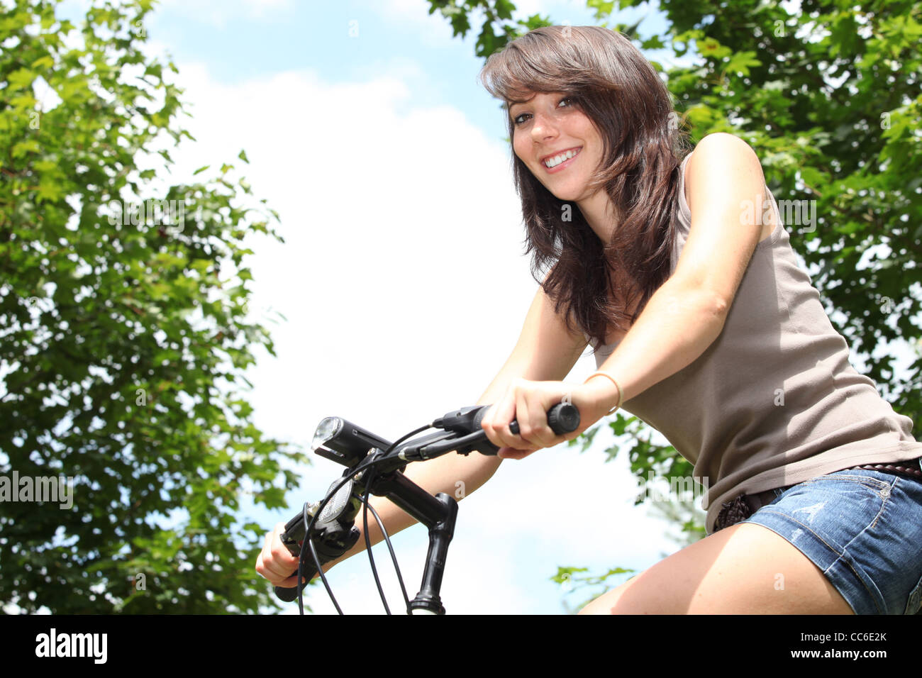 young woman riding bicycle Stock Photo - Alamy