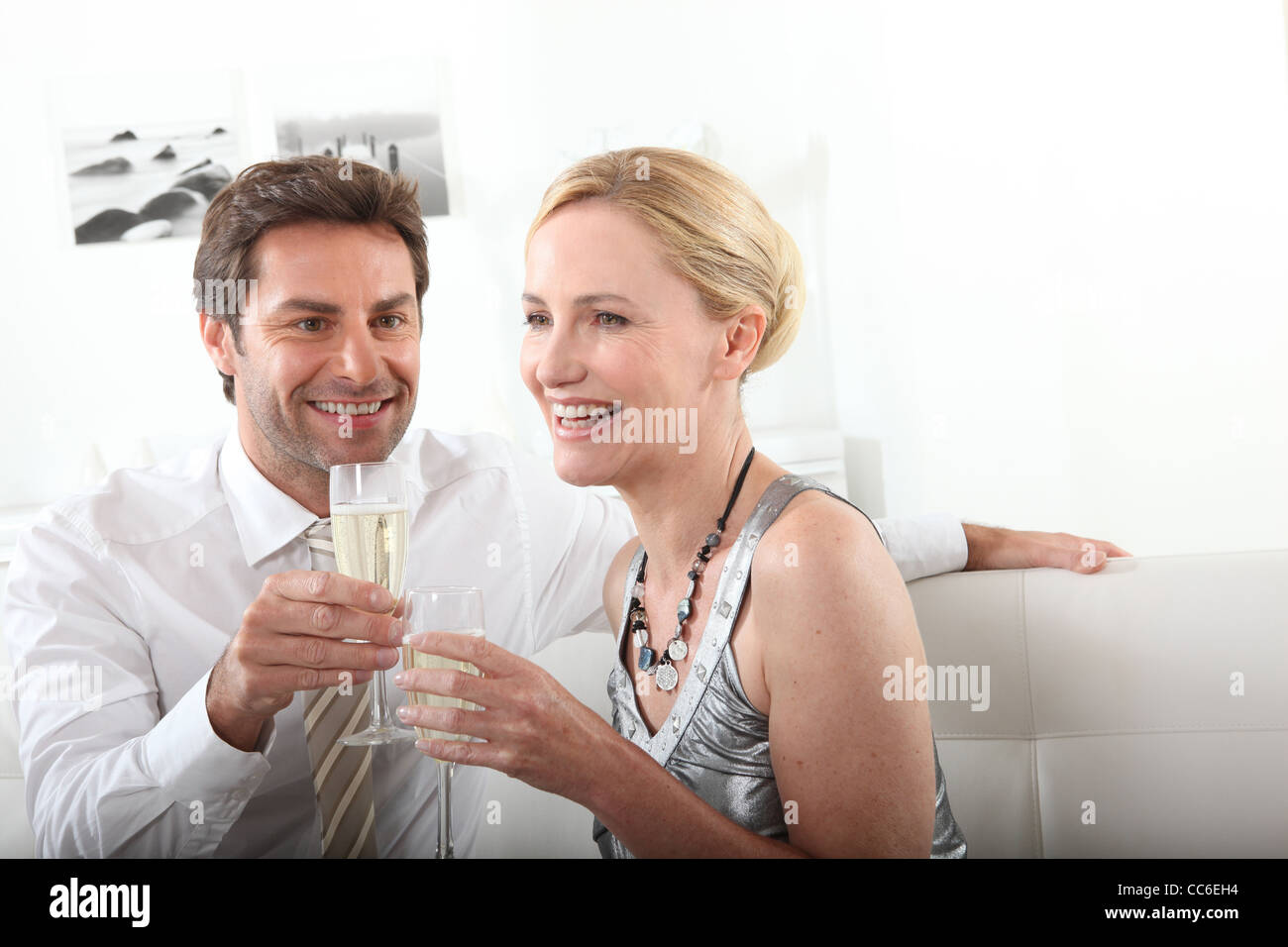 Couple drinking champagne at home Stock Photo - Alamy