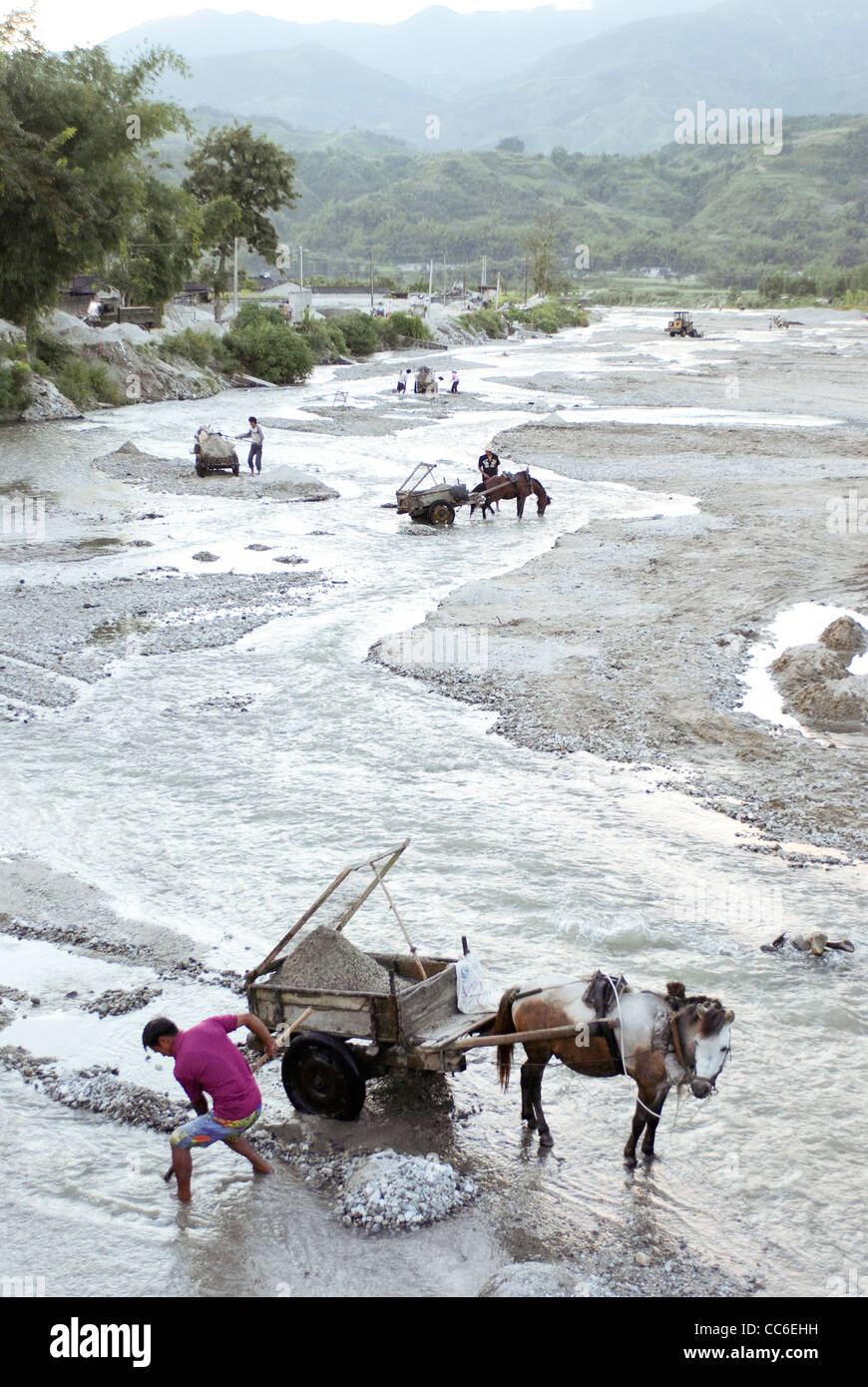 Men collecting sand for panning gold, Lianghe, Dehong, Yunnan , China ...
