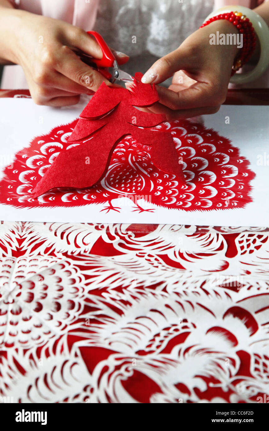 Woman making Chinese paper cutting, Beijing, China Stock Photo - Alamy