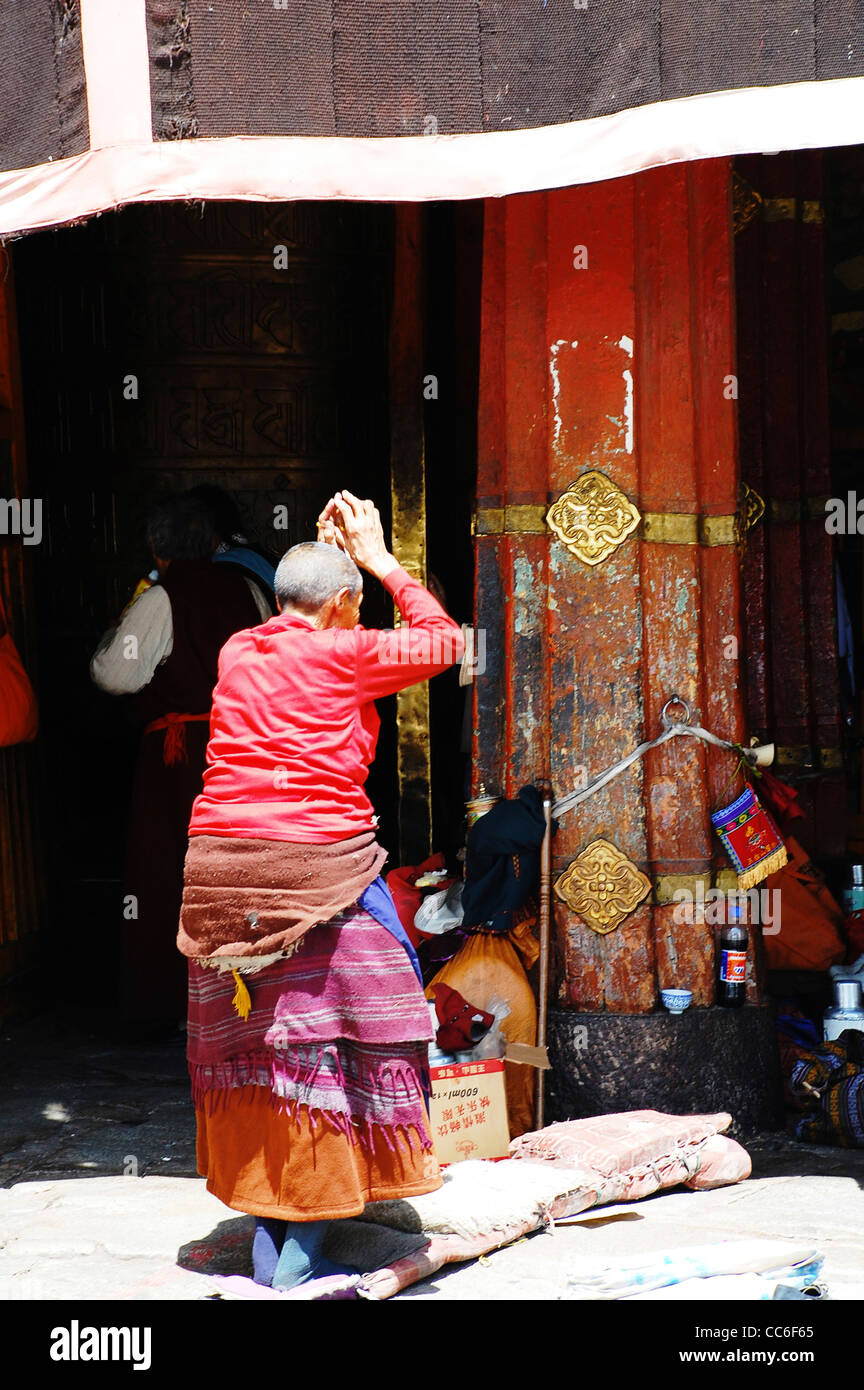 Elderly Tibetan pilgrim make full-body prostration in front of the ...