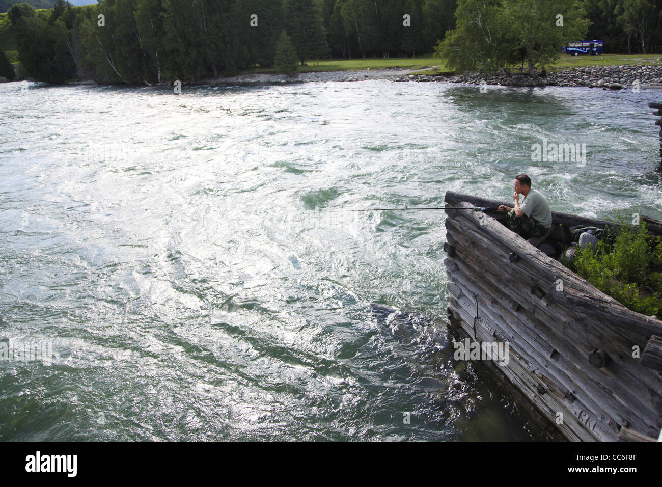 Man fishing on the Kanas Lake, Altay Prefecture, Xinjiang, China Stock ...