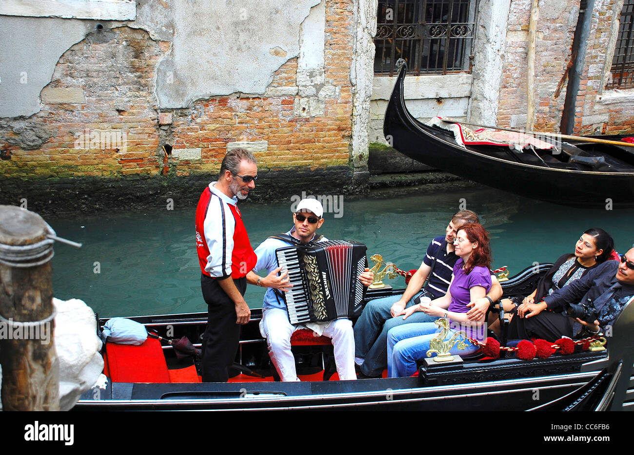 Caucasian performer singing for lovers on the gondola, Grand Canal ...