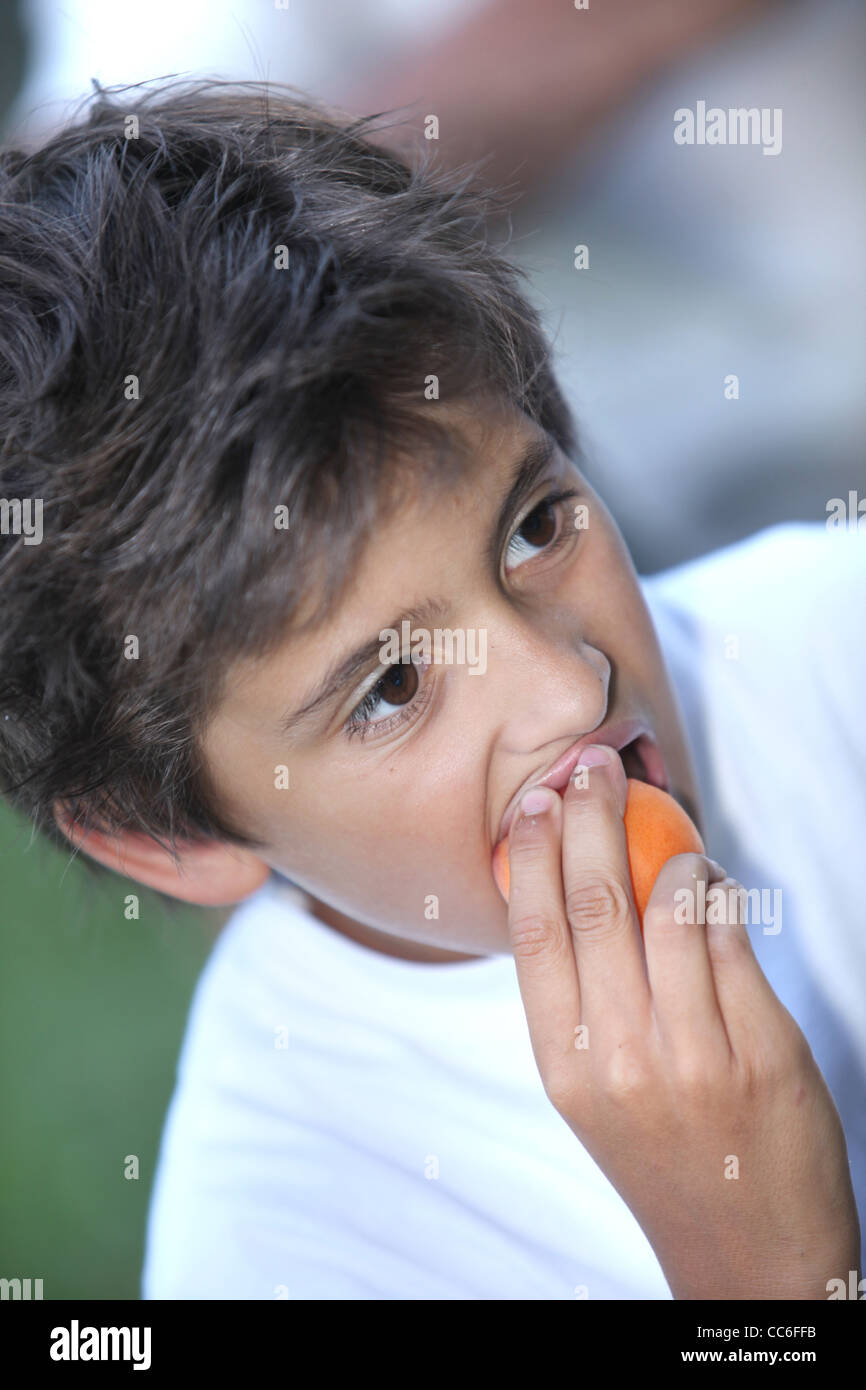 Little boy with apricot Stock Photo - Alamy