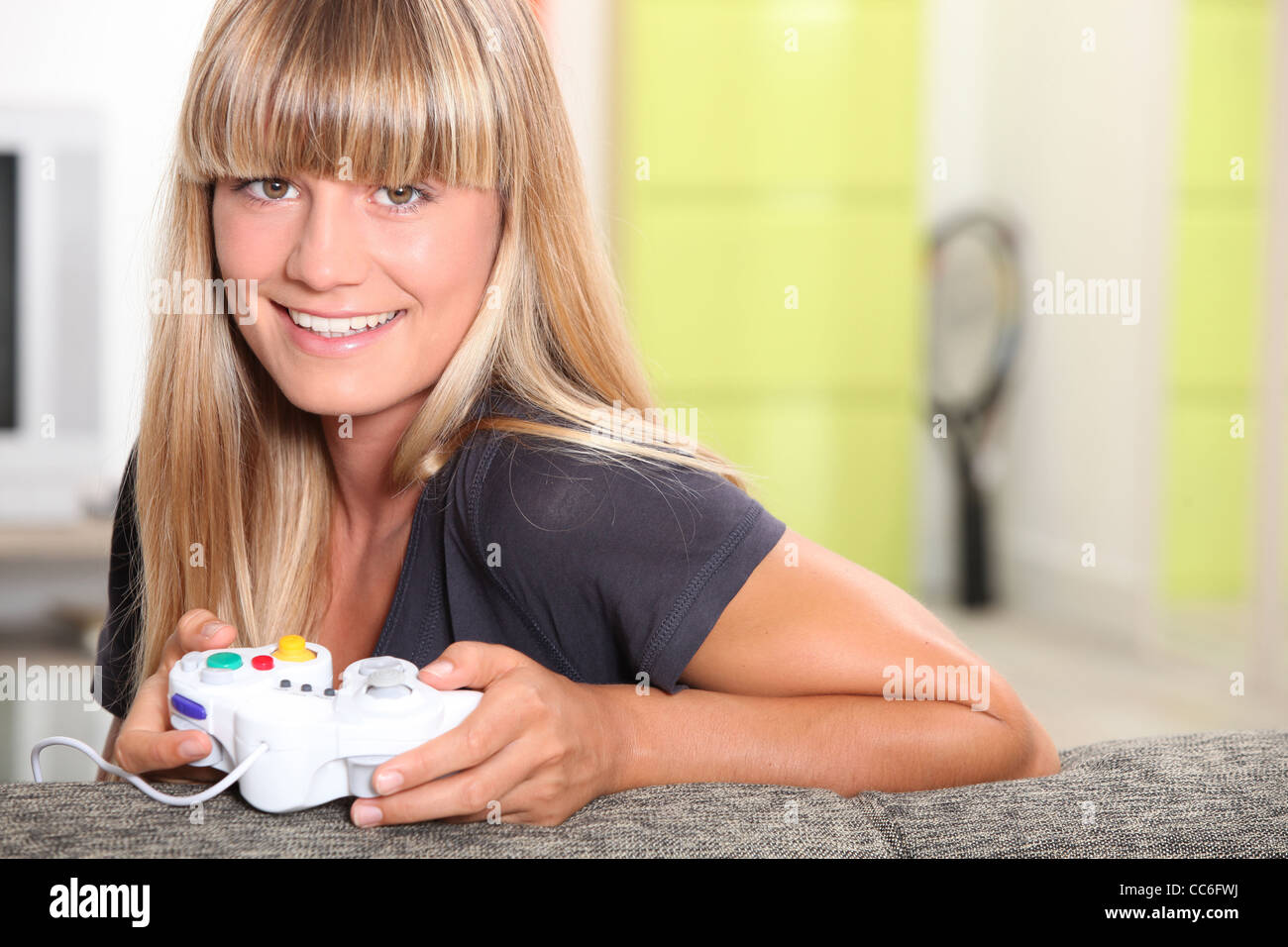Blonde girl playing with console Stock Photo - Alamy