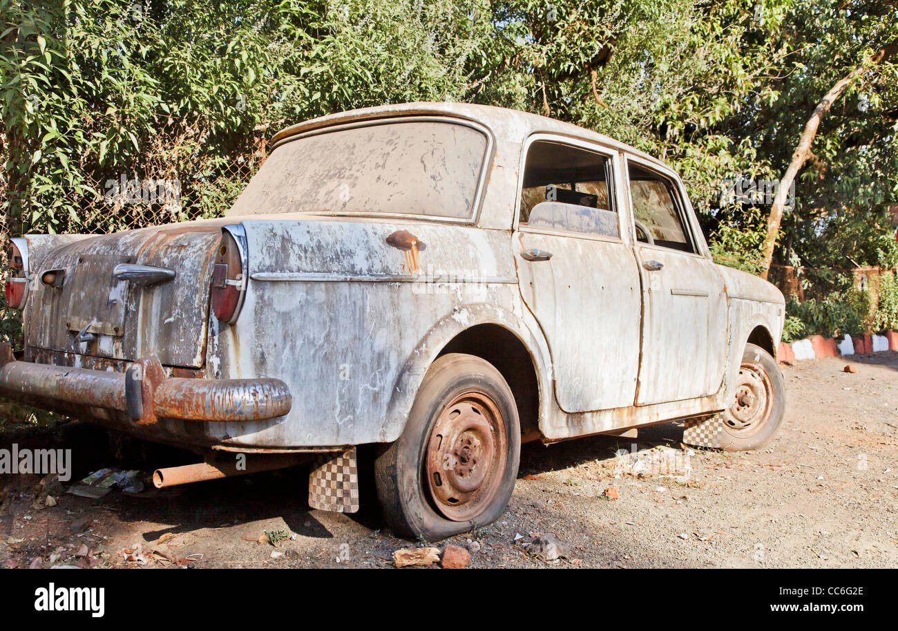 horizontal landscape of roadside scrap white car in India, copy area ...