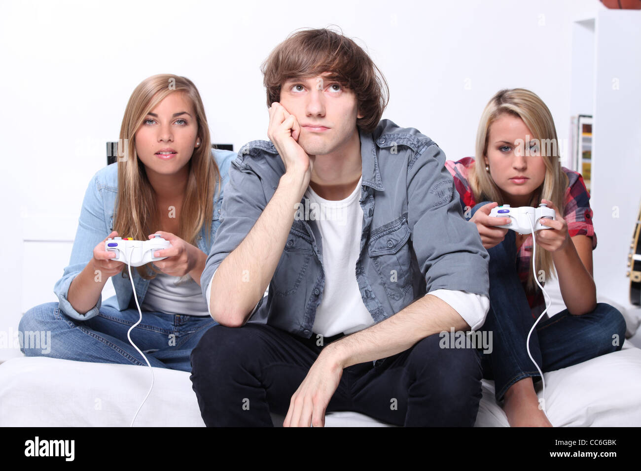 Three teenagers playing computer game Stock Photo - Alamy