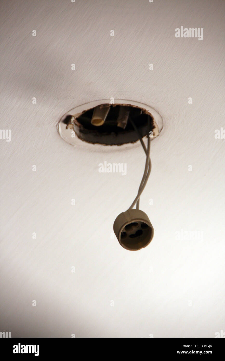 broken light fitting on roof ceiling in house home property Stock Photo ...