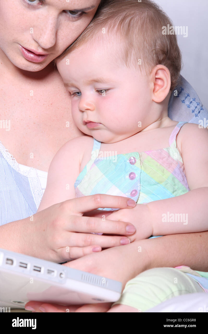 Woman cuddling her baby Stock Photo - Alamy