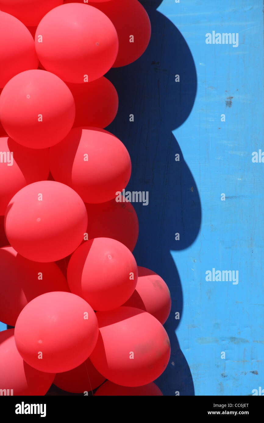 lots of red balloons on carnival float truck lorry Stock Photo - Alamy