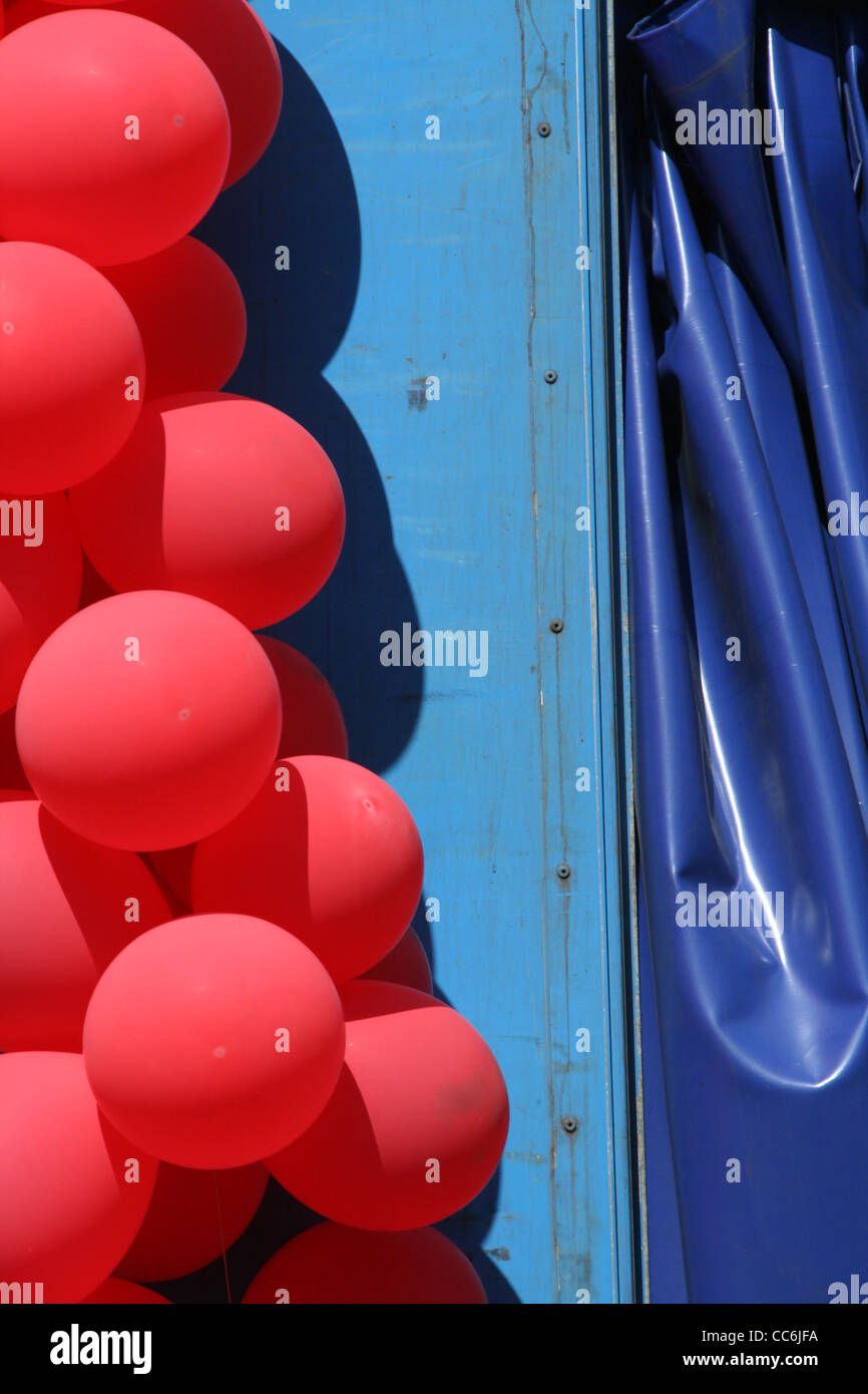 lots of red balloons on carnival float truck lorry Stock Photo - Alamy