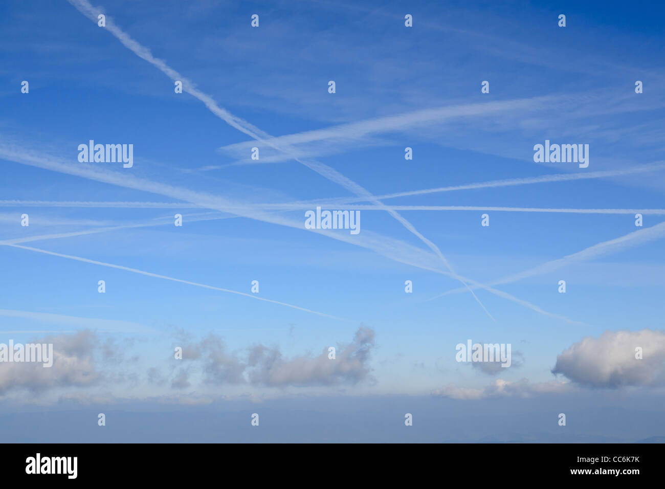 Crossing clouds of airplanes condensation vapour on blue sky Stock ...