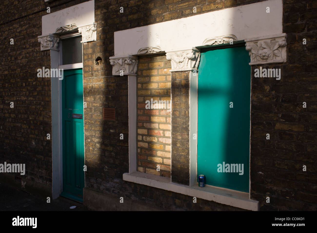 A half-bricked up and painted Victorian terraced house window Stock ...