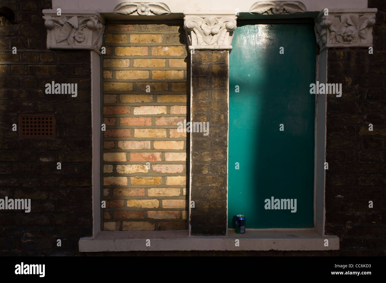 A half-bricked up and painted Victorian terraced house window Stock ...