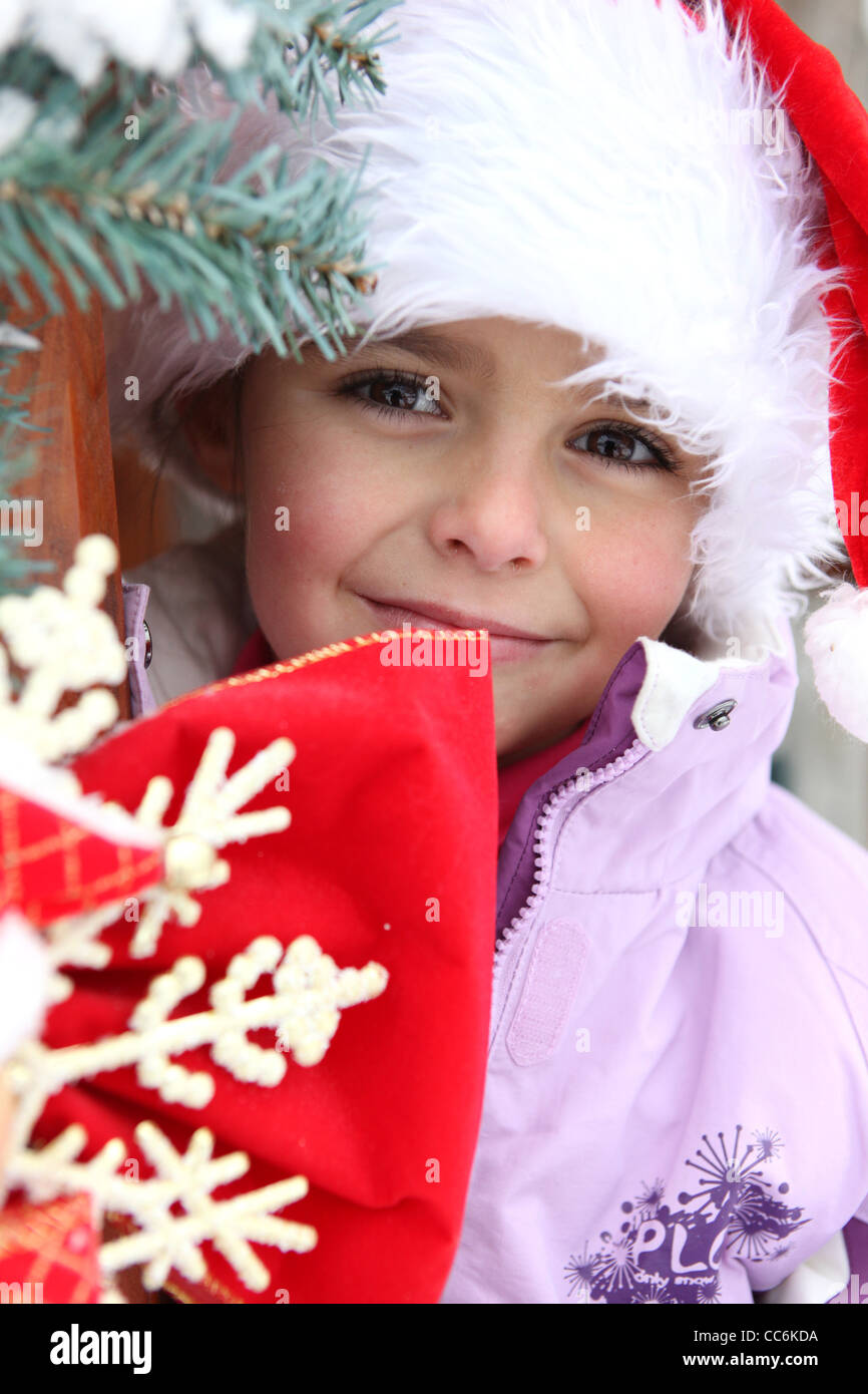 Little girl in a Santa hat Stock Photo - Alamy