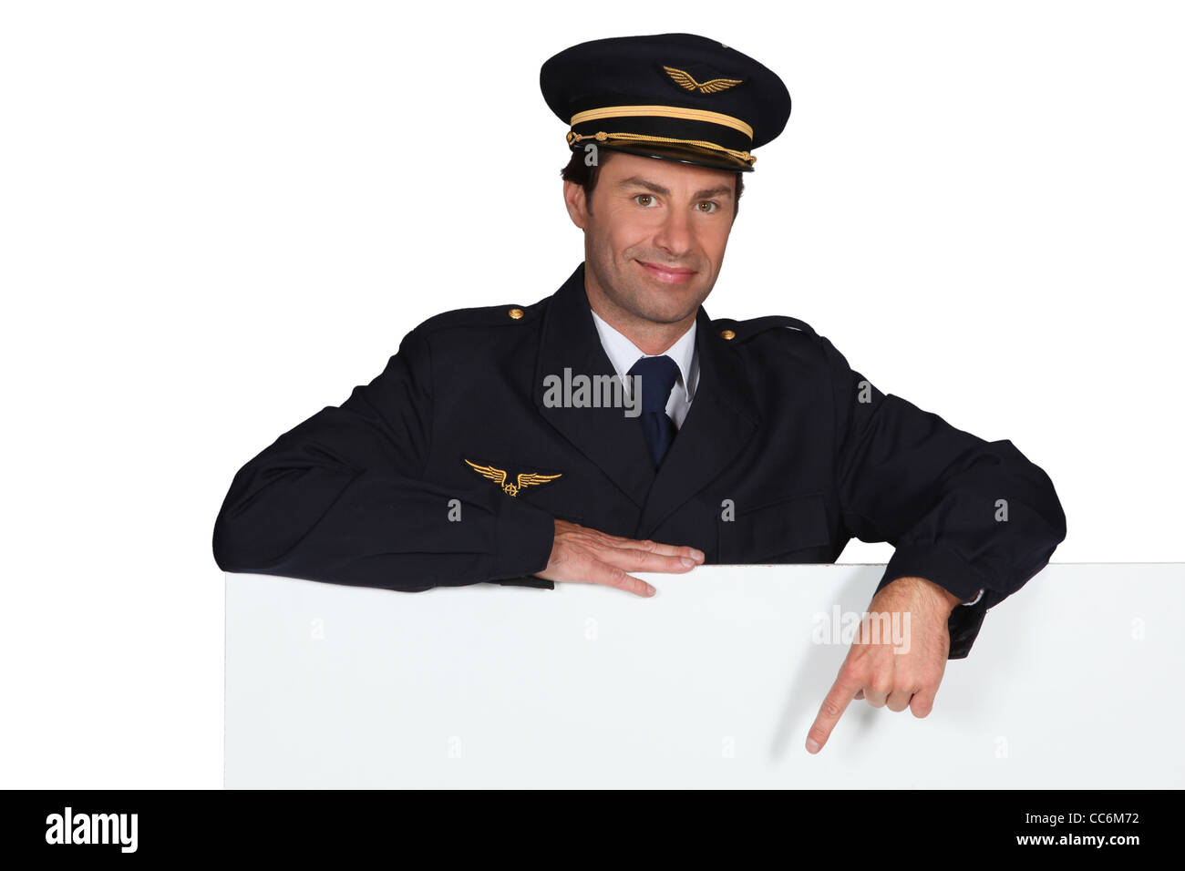 Pilot pointing at advertising board Stock Photo - Alamy