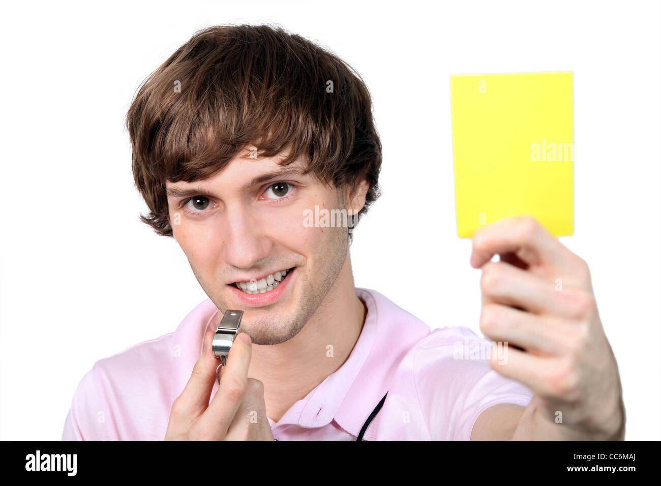Referee showing the yellow card Stock Photo - Alamy