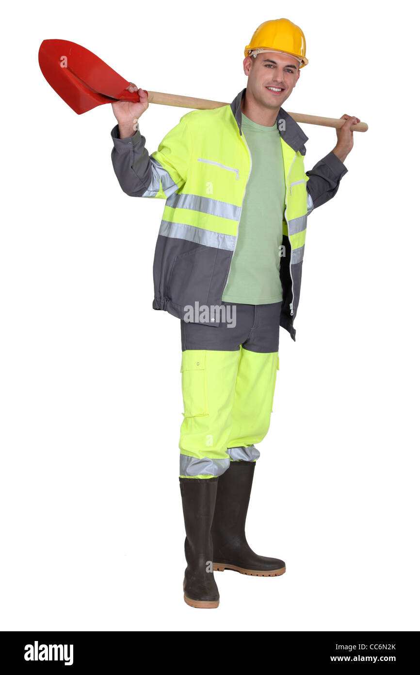 Man holding spade over shoulder Stock Photo - Alamy