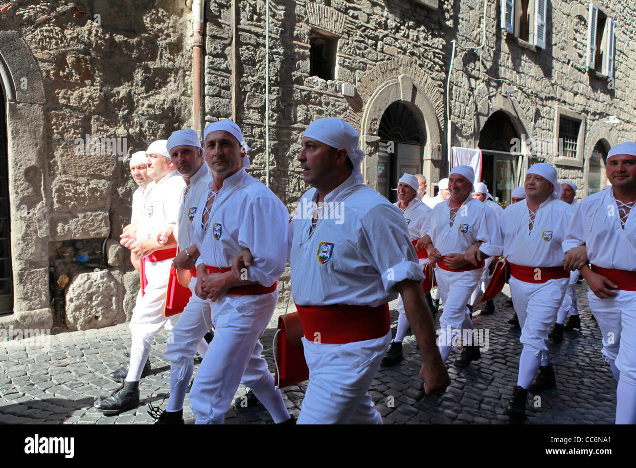 Facchini from Viterbo in Italy marching through the town's streets ...