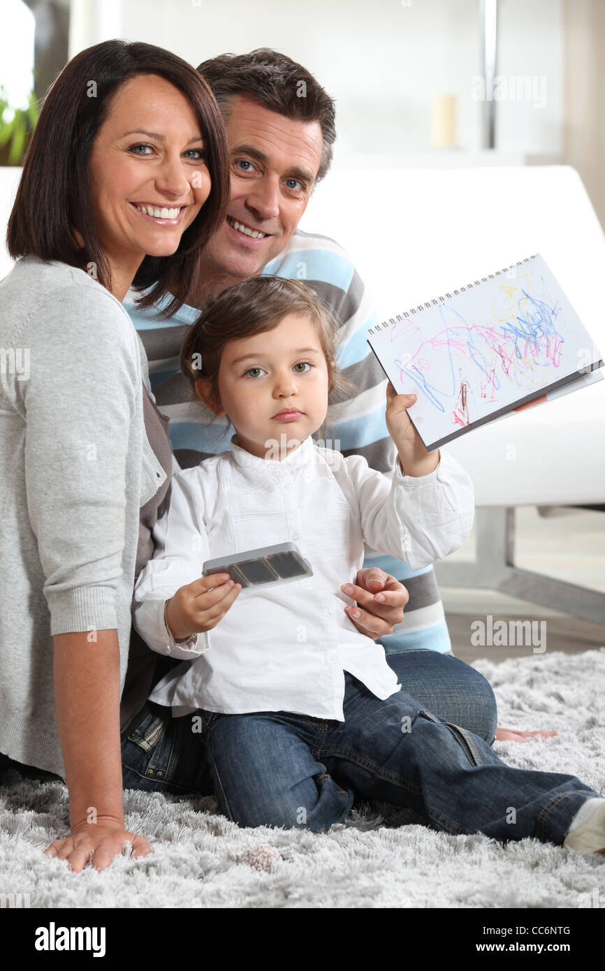 Little girl drawing picture for parents Stock Photo - Alamy